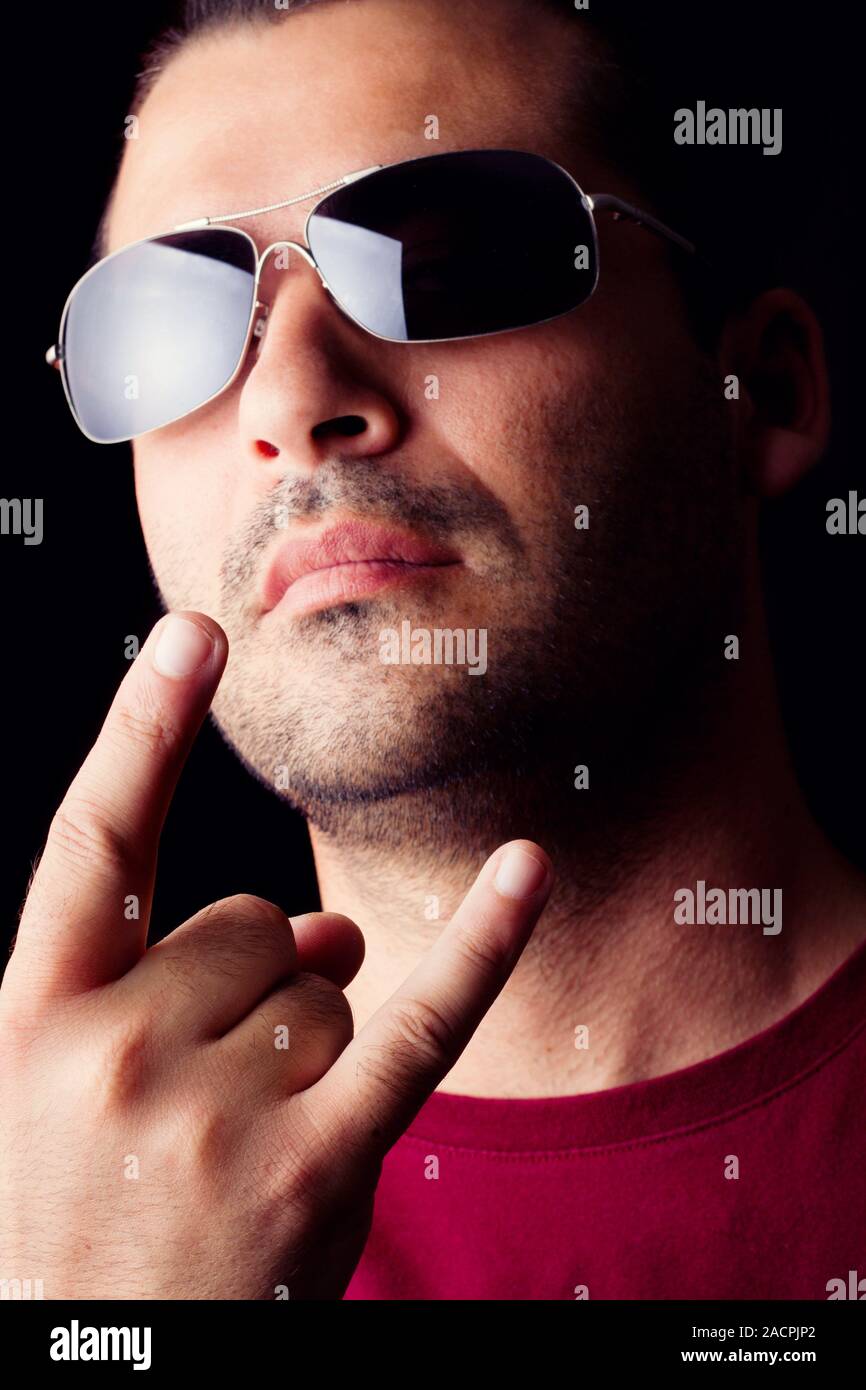 male man with dark shades making signs Stock Photo - Alamy