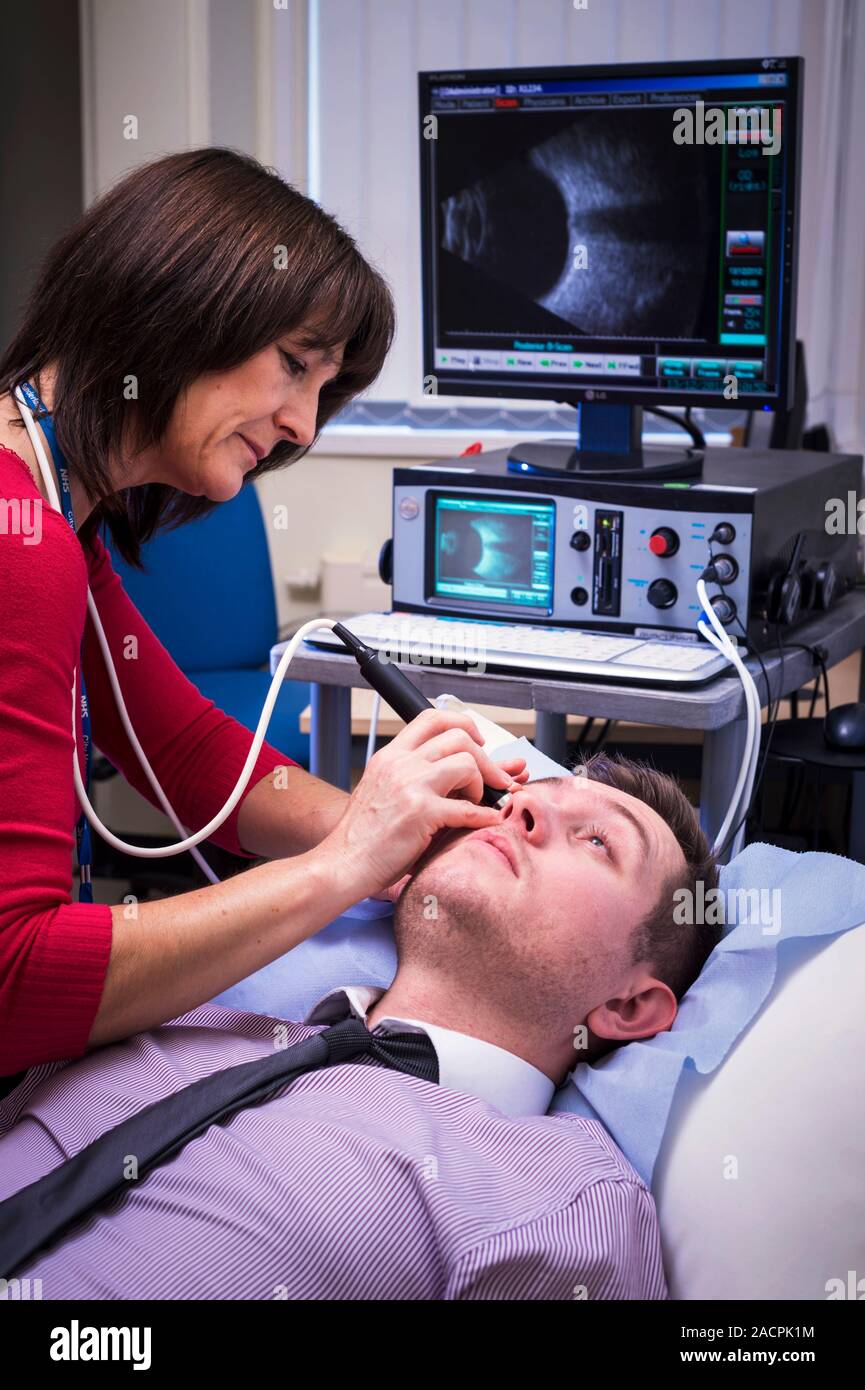 Ultrasound eye examination. Ophthalmologist using an ultrasound ...