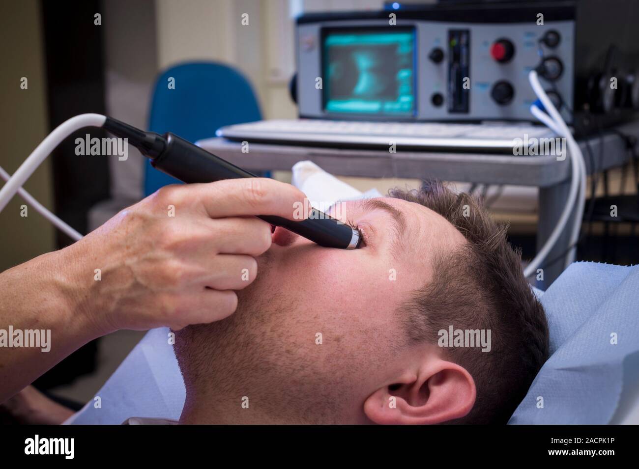 Ultrasound eye examination. Hand of an ophthalmologist applying a ...