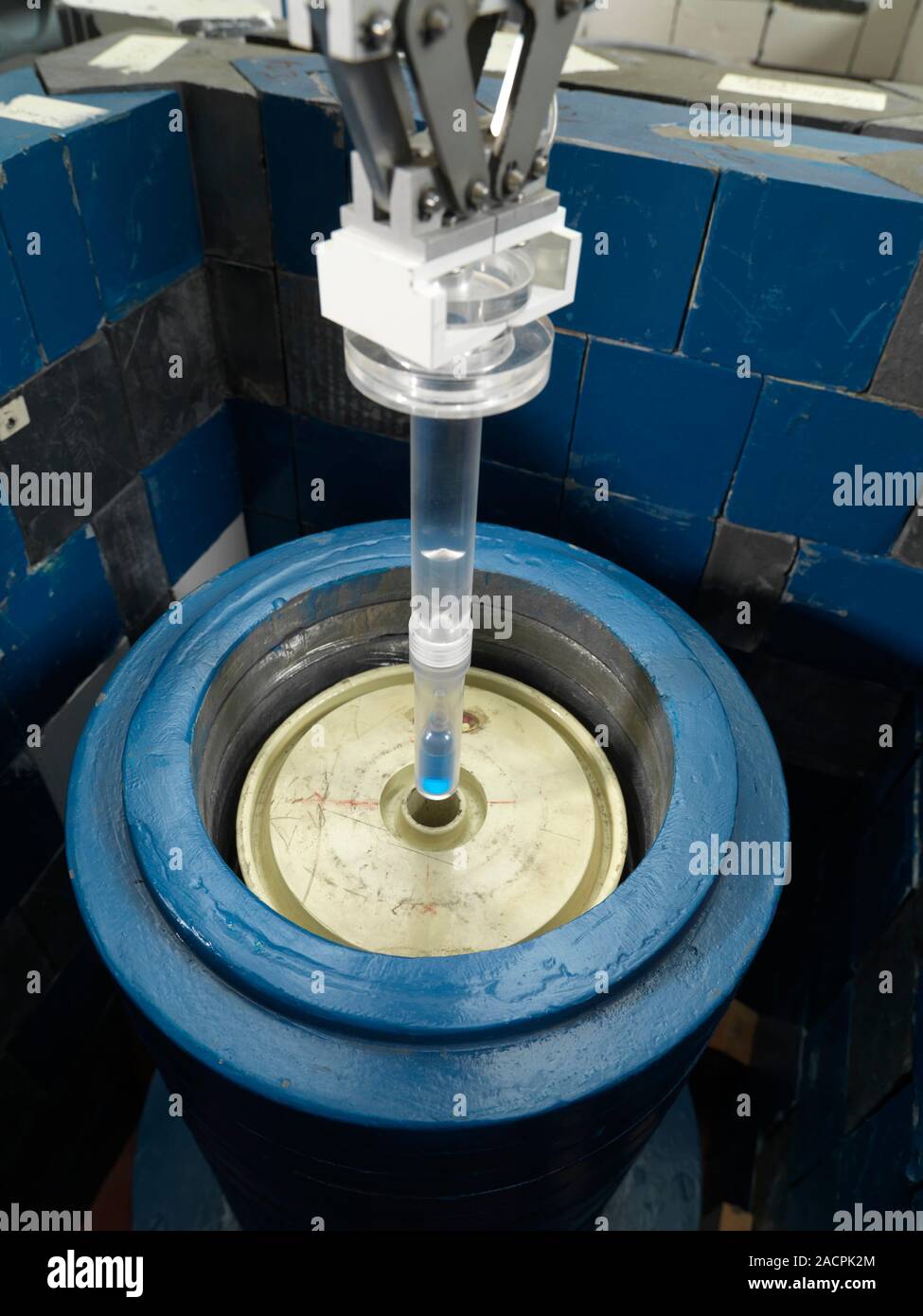 Ionisation chamber system. Robotic arm of an automatic sample changer ...