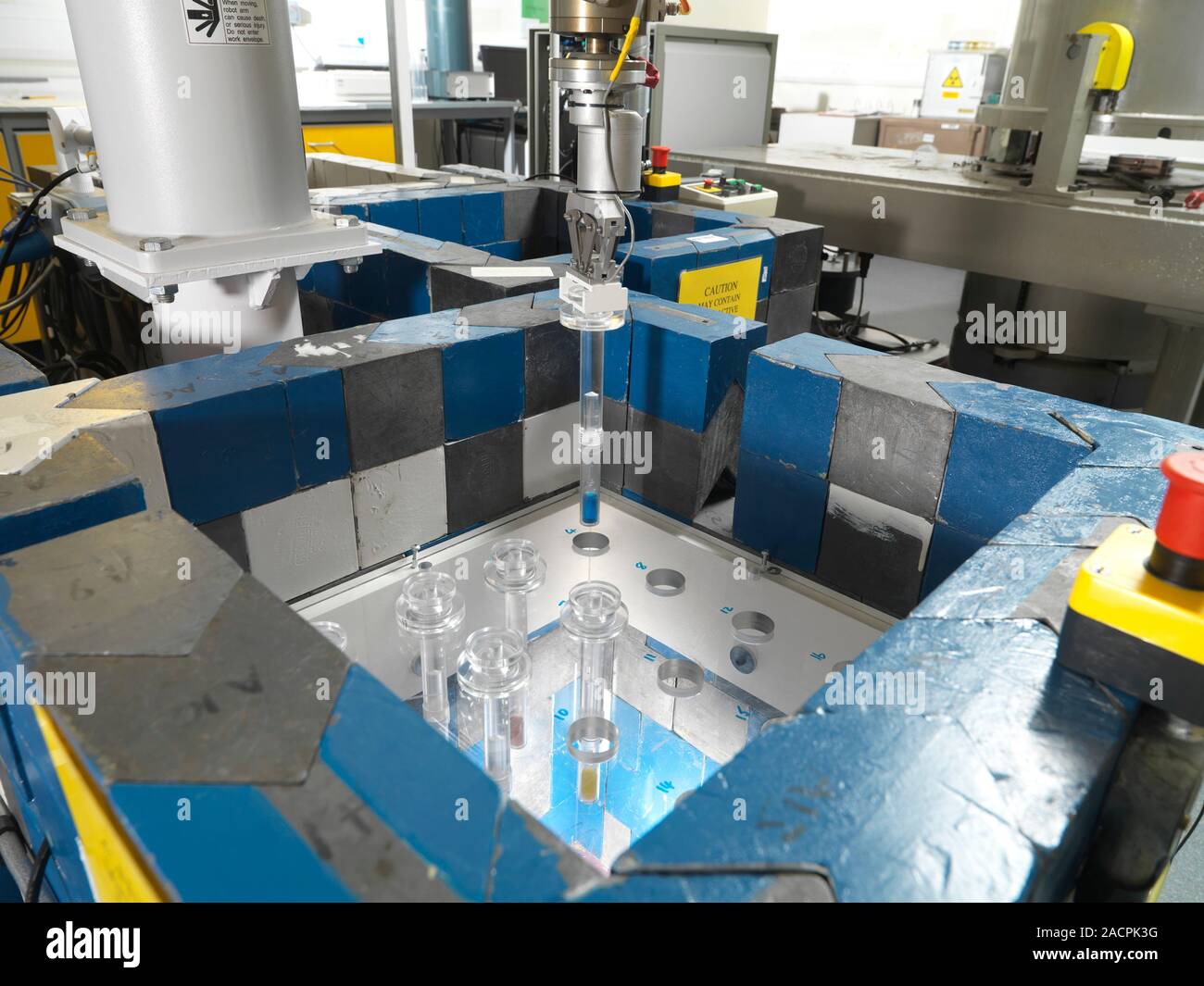 Automatic sample changer. Robotic arm removing a radioactive sample ...