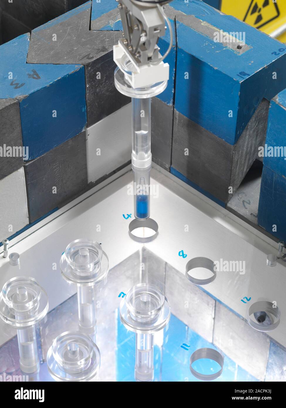 Automatic sample changer. Robotic arm removing a radioactive sample ...