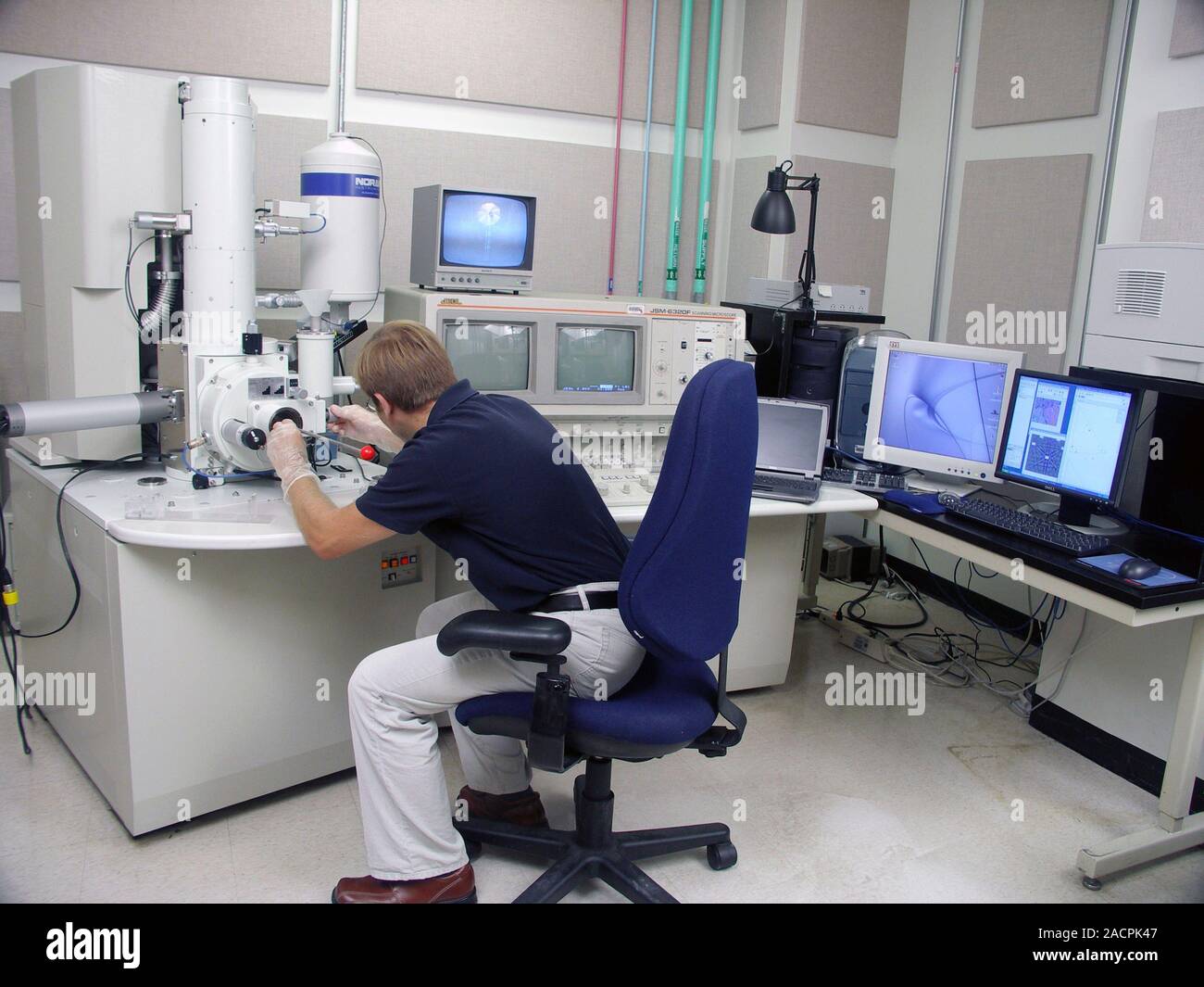 FE scanning electron microscopy. Researcher operating a field-emission scanning electron ...