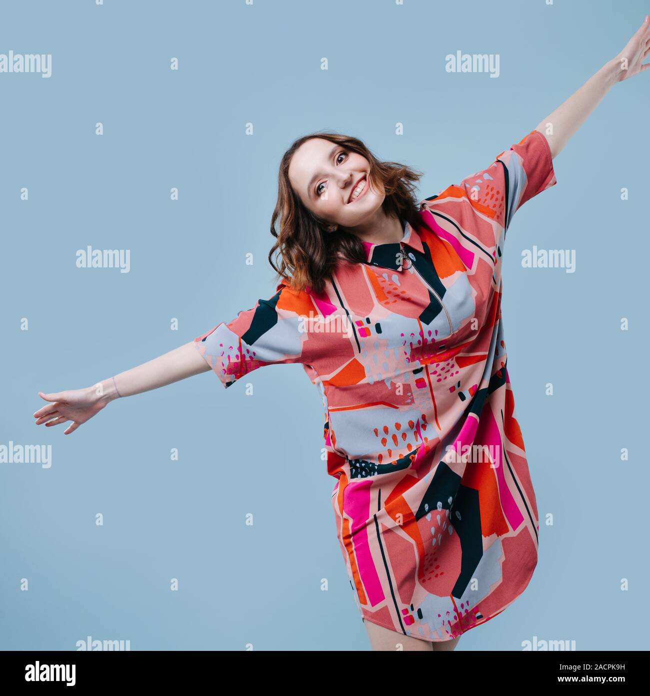 Girl portray plane, arms outstretched, in a good mood Stock Photo - Alamy