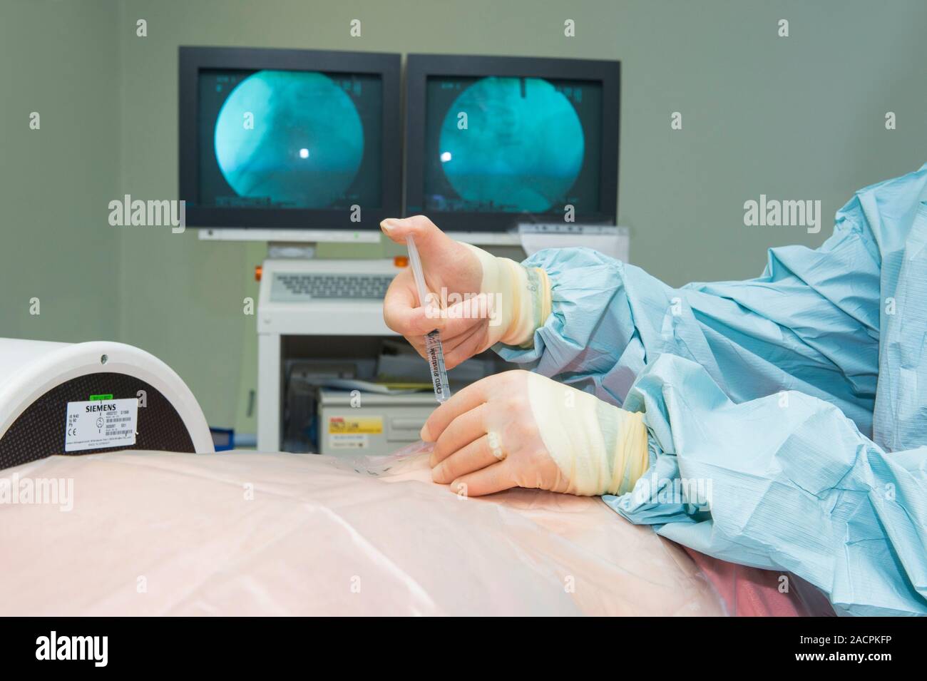 Lower back pain treatment. Close-up of a 60-year-old woman undergoing ...