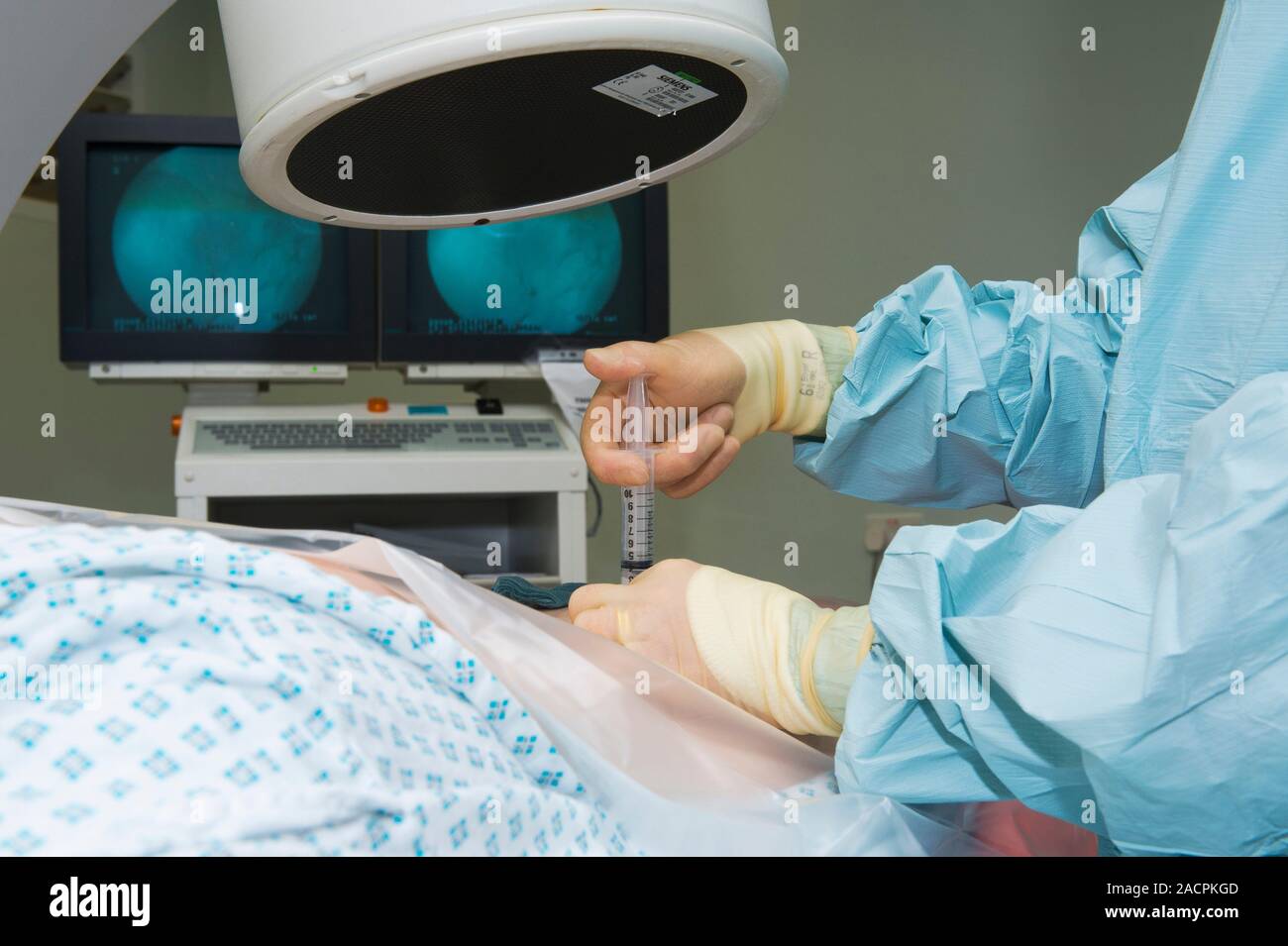 Lower back pain treatment. 60-year-old woman undergoing nerve root ...