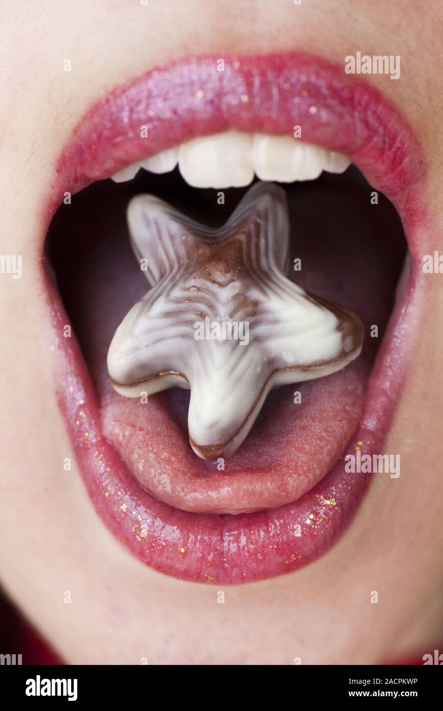 chocolate star on tongue Stock Photo - Alamy