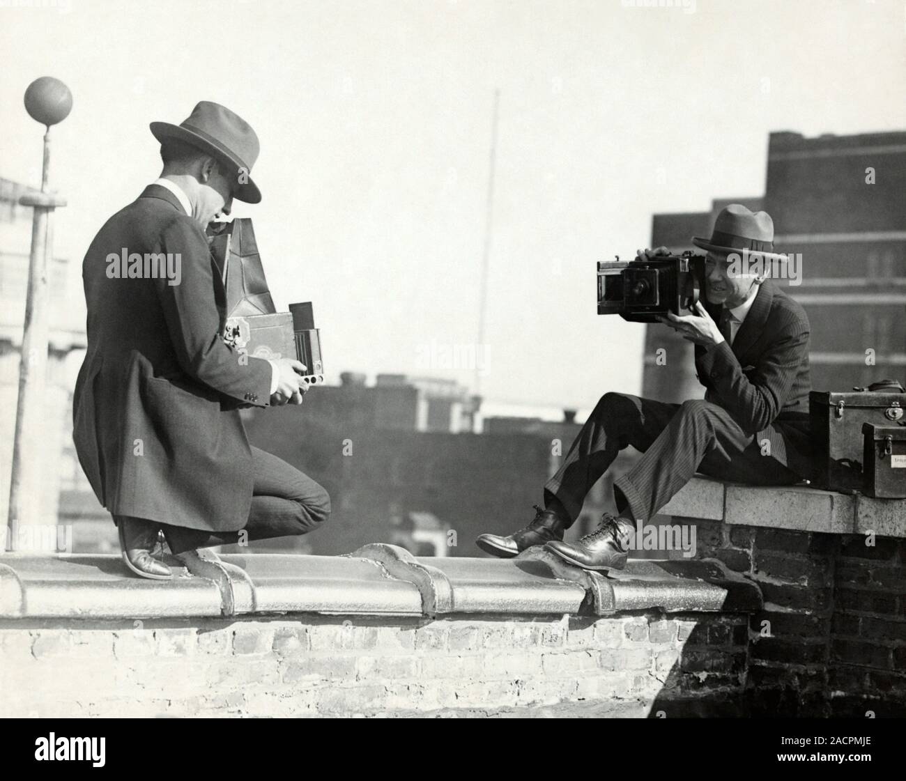 Handheld photography, early 20th century. Two photographers taking ...