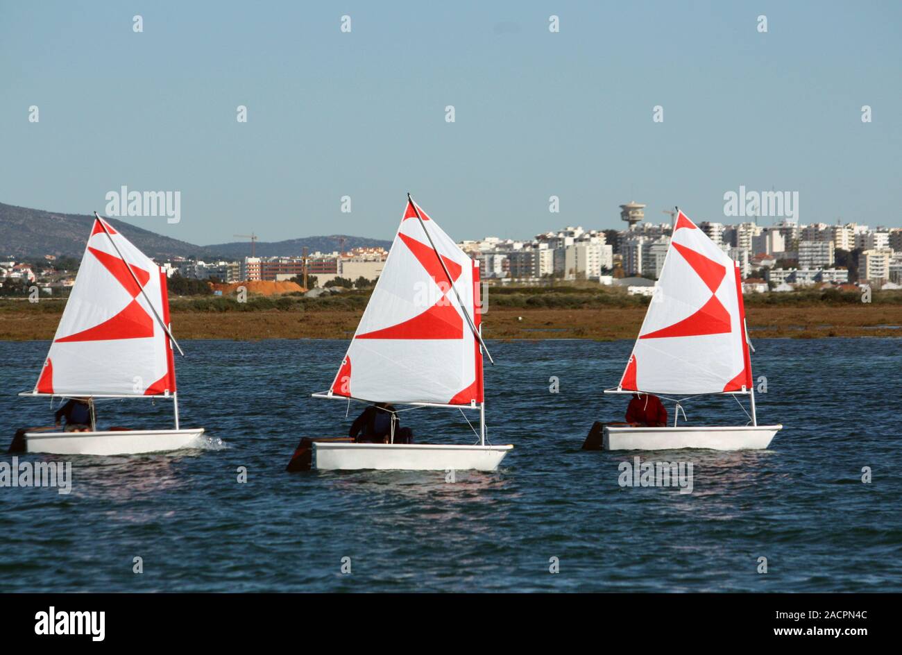 Three on a row Stock Photo - Alamy