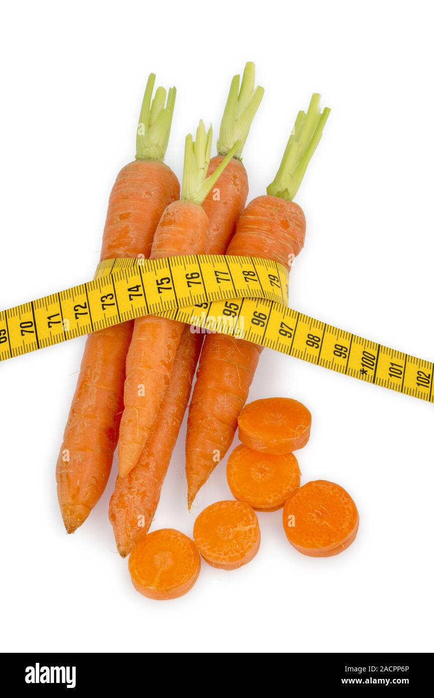 Fresh carrots with tape measure Stock Photo - Alamy