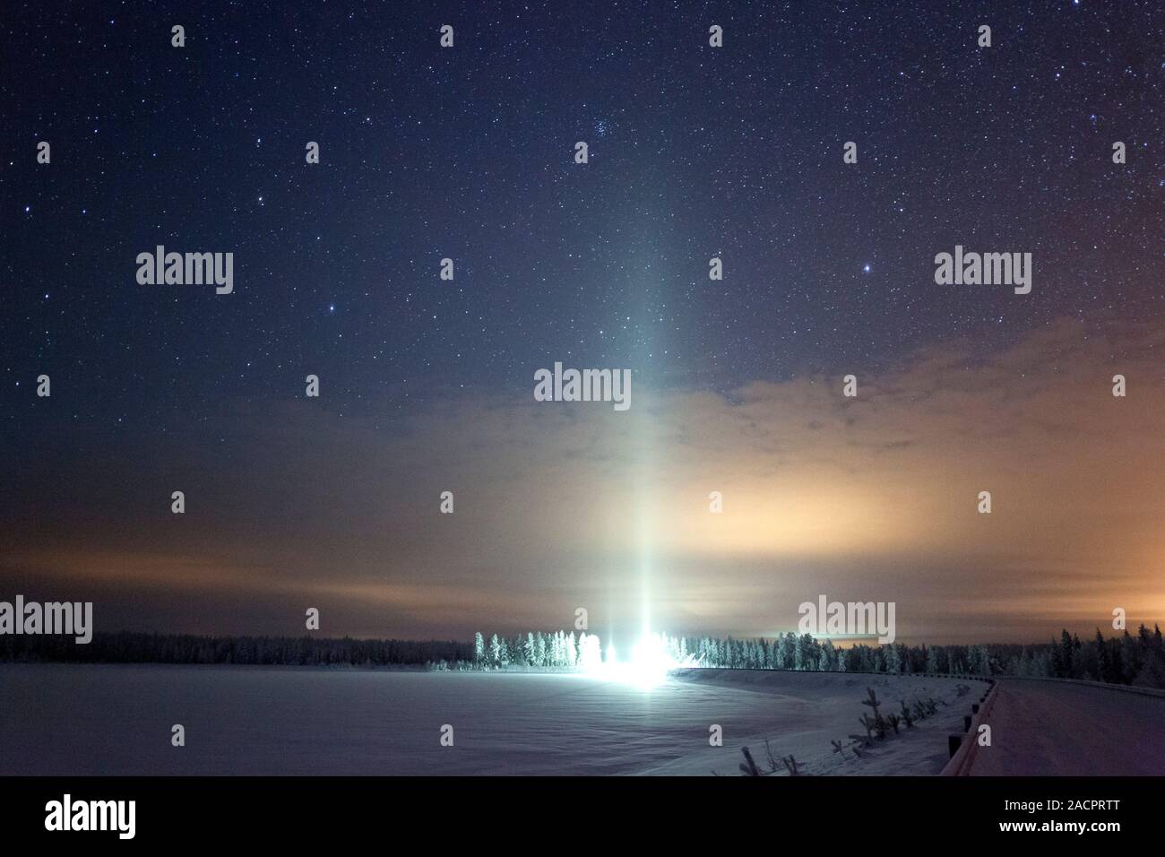 Ice pillar in night sky. This atmospheric optical phenomenon is formed ...