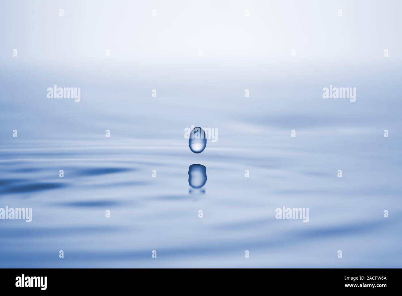 Water drop falling into the ocean. The phrase 'a drop in the ocean' is ...