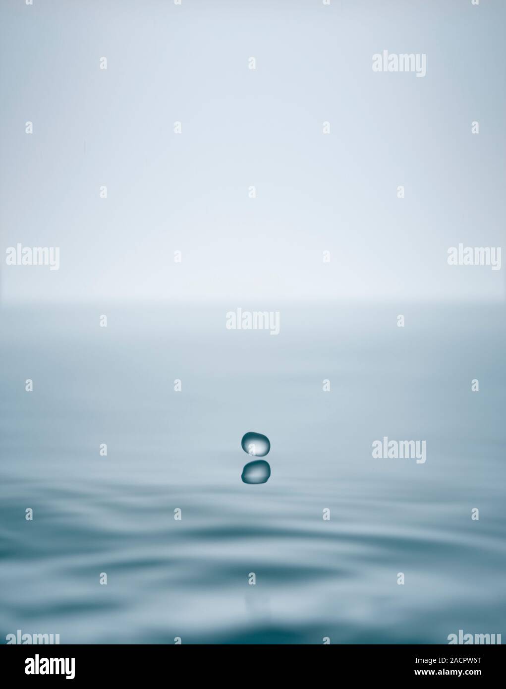 Water drop falling into the ocean. The phrase 'a drop in the ocean' is ...