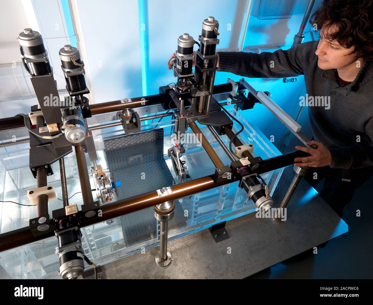 Ultrasound beam plotting tests. Researcher carrying out tests with ...