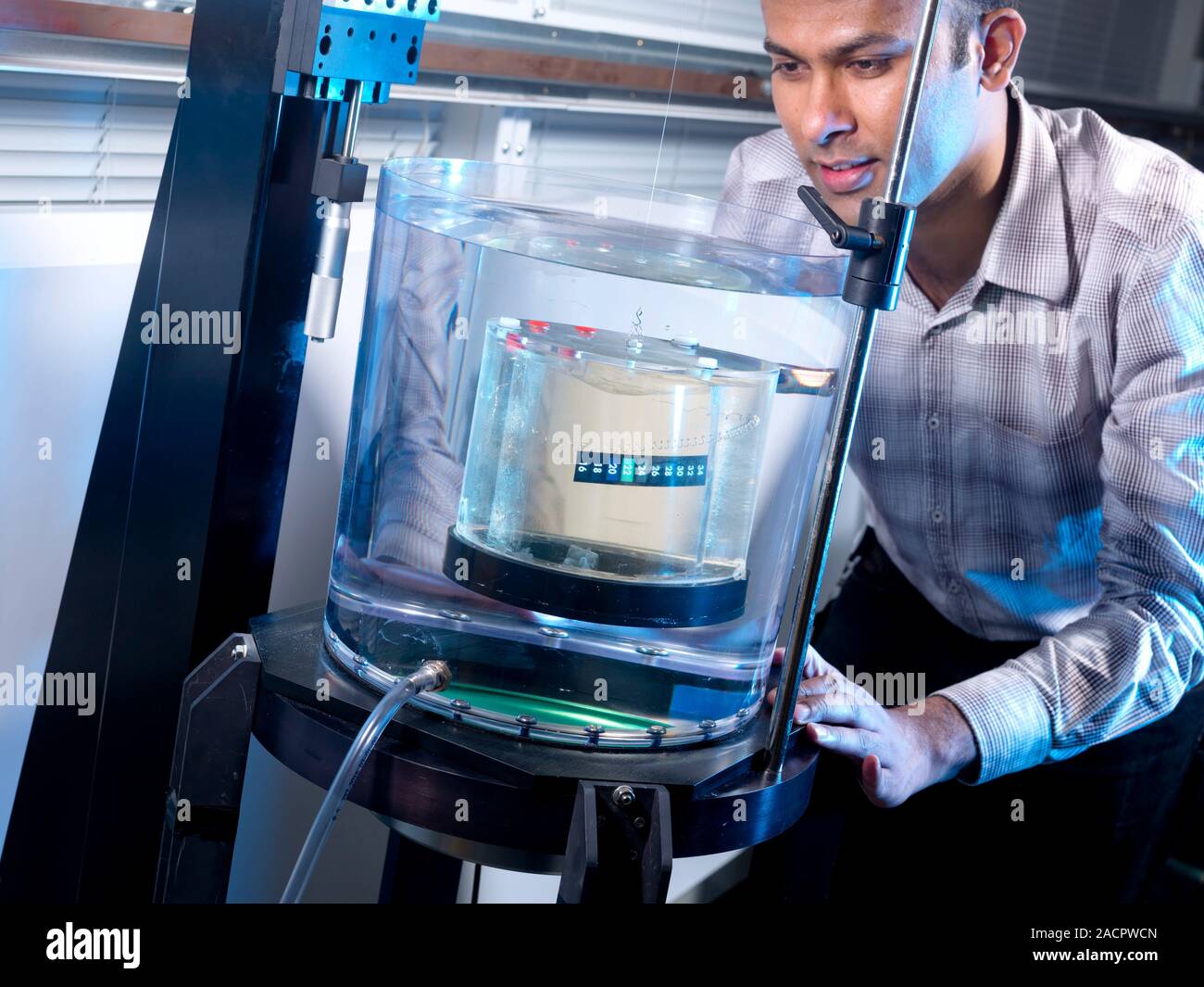 Ultrasound power tests. Researcher carrying out buoyancy tests to ...