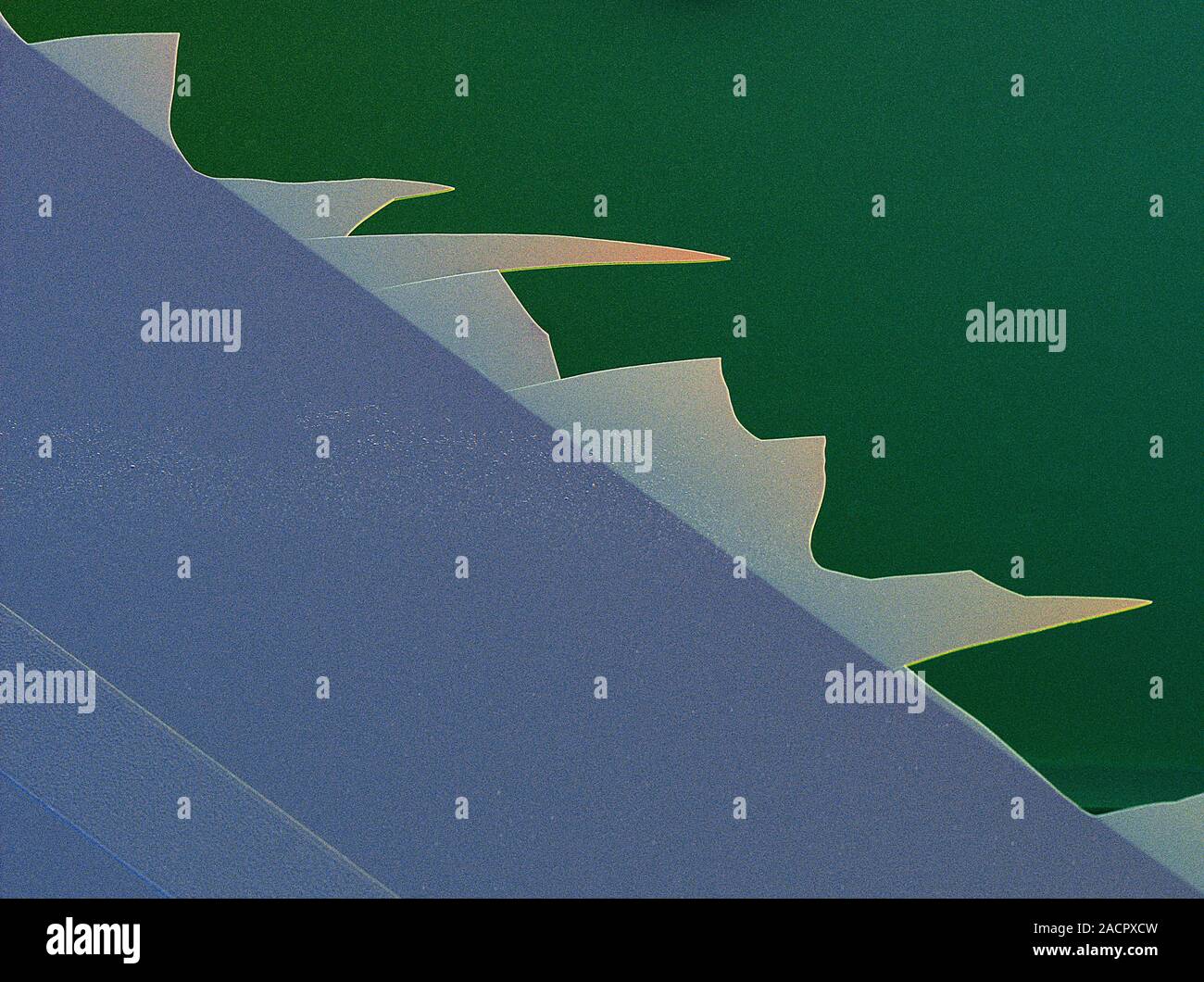 Damaged MEMS hydrogel sensor. Coloured scanning electron micrograph of ...