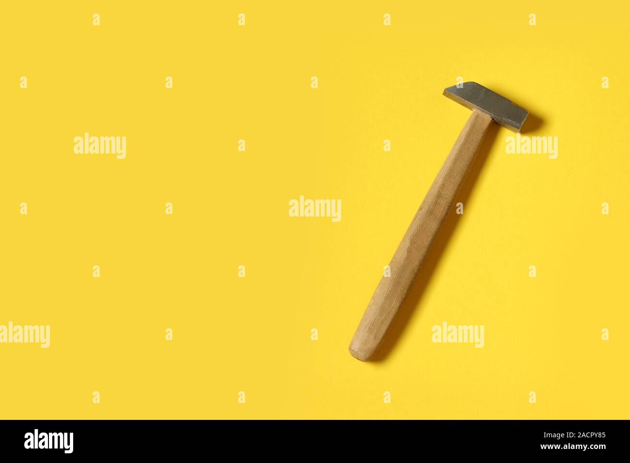 Small metal hammer on a yellow background with copy space Stock Photo ...