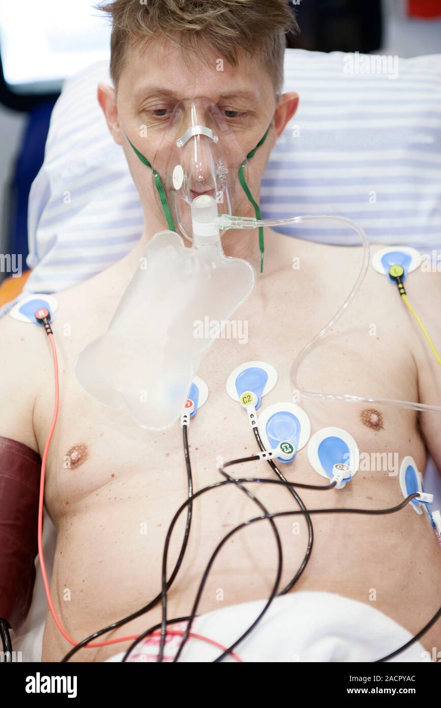 Cardiac patient in an ambulance. 50-year-old cardiac patient undergoing ...