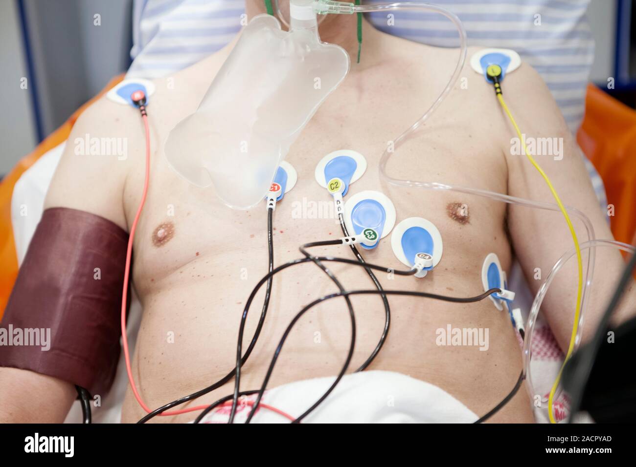 Cardiac patient in an ambulance. 50-year-old cardiac patient undergoing ...