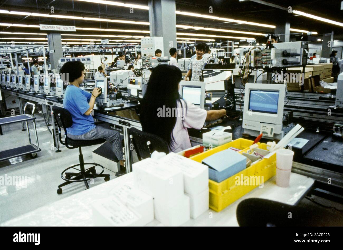 Computer assembly plant. Workers assembling computers at factory in ...