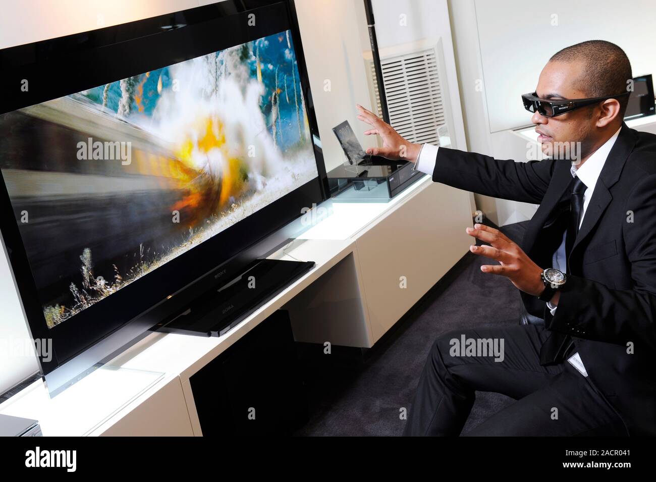 3D television. Man watching a 3D television with special glasses Stock ...