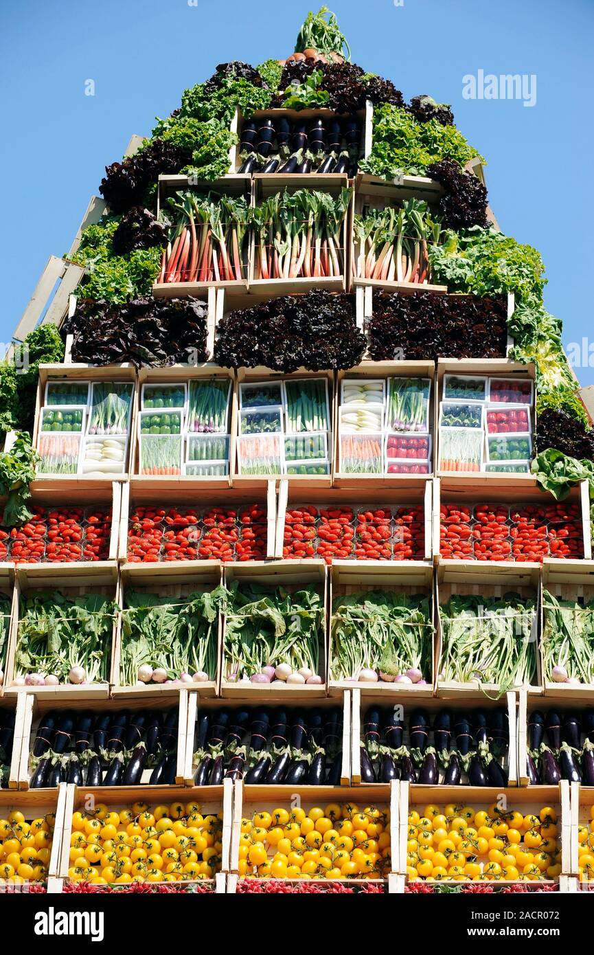 Vegetable pyramid. Crates of fresh vegetables stacked to form a pyramid ...