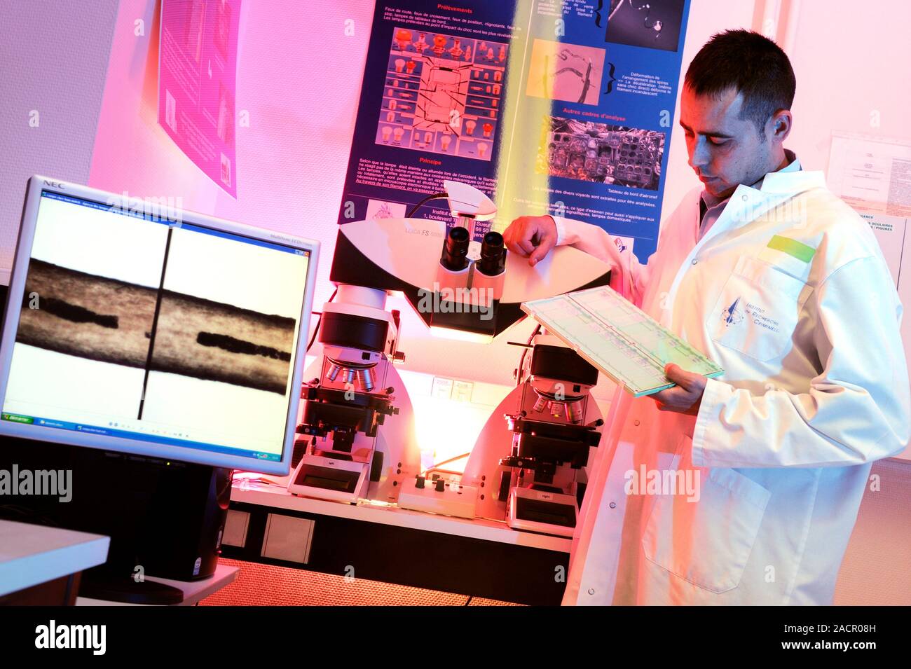Forensic hair analysis. Forensic scientist using a microscope to ...