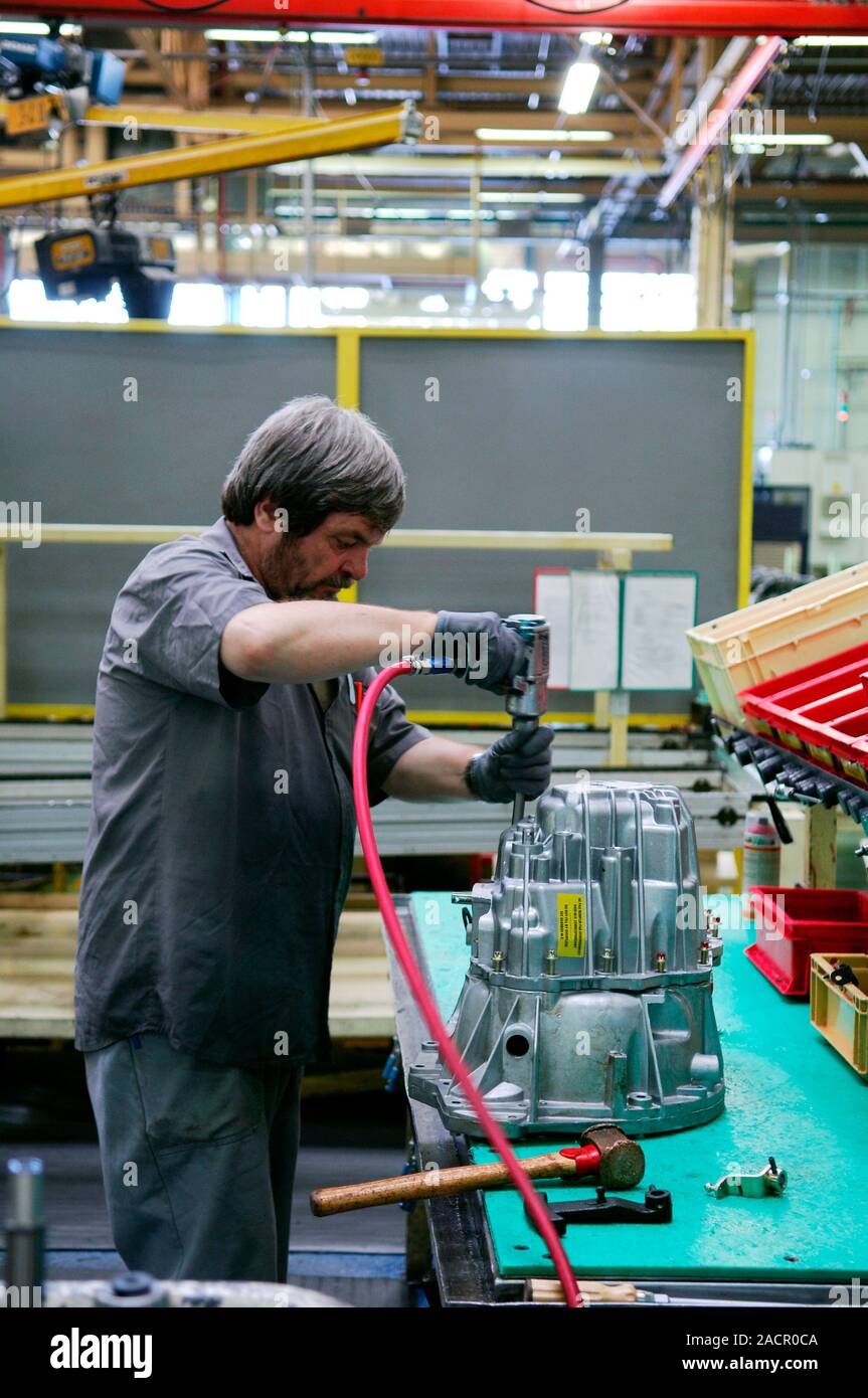 Car spare parts factory. Worker in the Renault spare parts factory ...