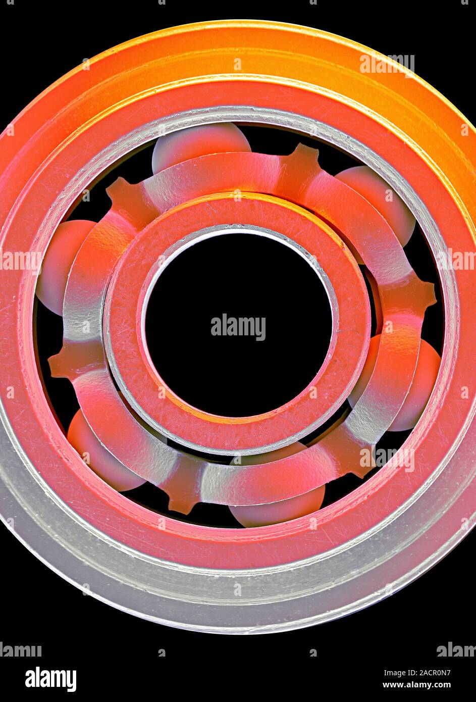 Miniature ball bearing. Coloured scanning electron micrograph (SEM) of ...