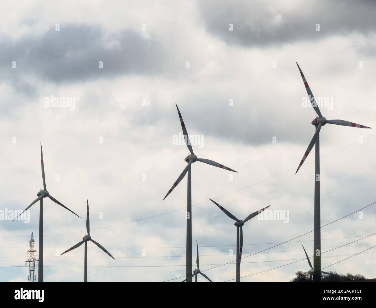 Wind turbine and power pylons Stock Photo - Alamy