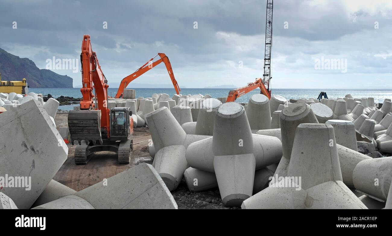 Coastal defence construction. Precast concrete blocks being lined up ...