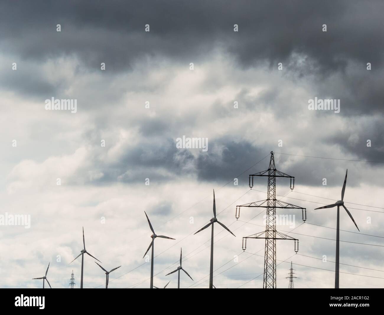 Wind turbine and power pylons Stock Photo - Alamy