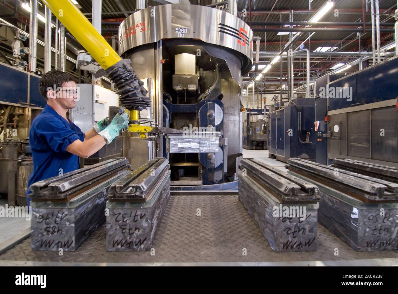Manufacturing solar panels. Worker at a factory that manufactures solar ...