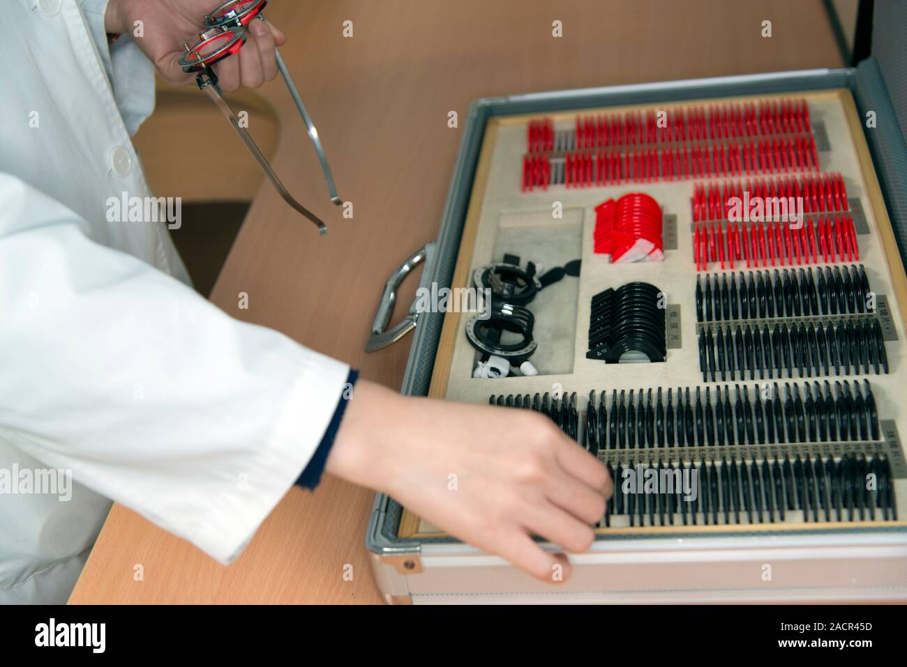 Eye test. Ophthalmologist with a set of test lenses and trial frames ...