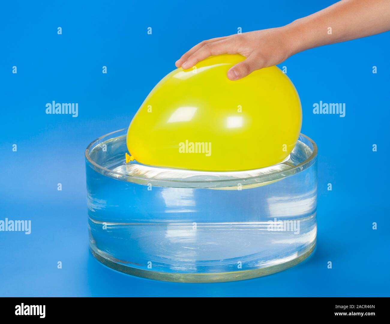 Volume displacement experiment. Experiment showing that a balloon ...