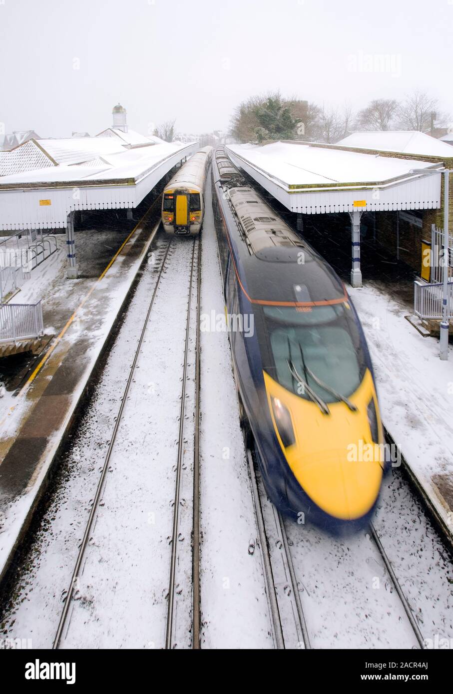 Trains in winter at a train station. At right is a British Rail Class ...