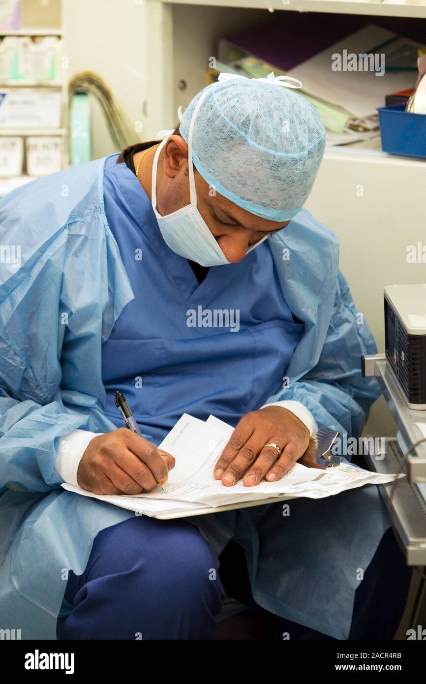Surgeon writing notes Stock Photo - Alamy