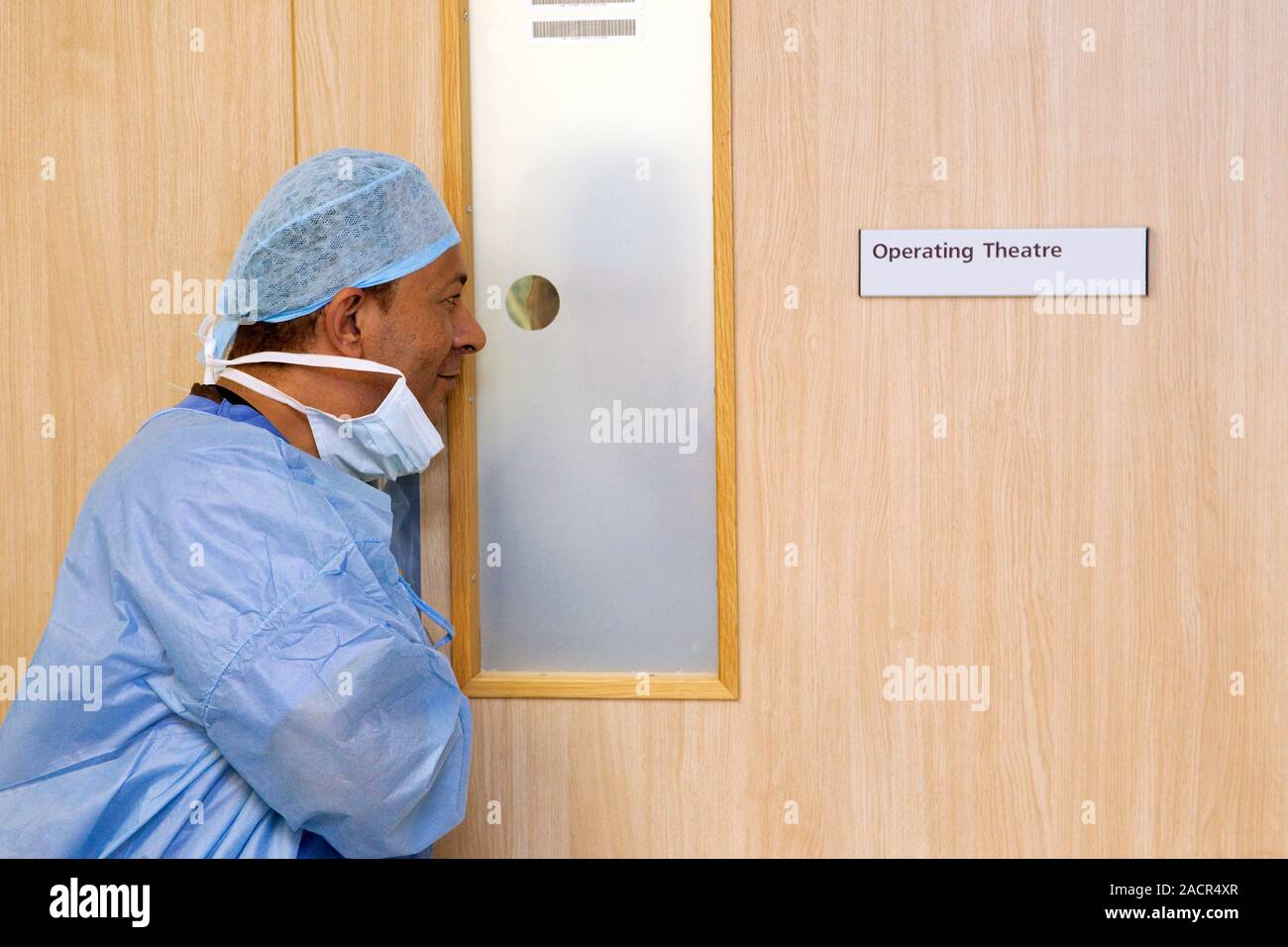 Surgeon watching an operation through a window Stock Photo - Alamy