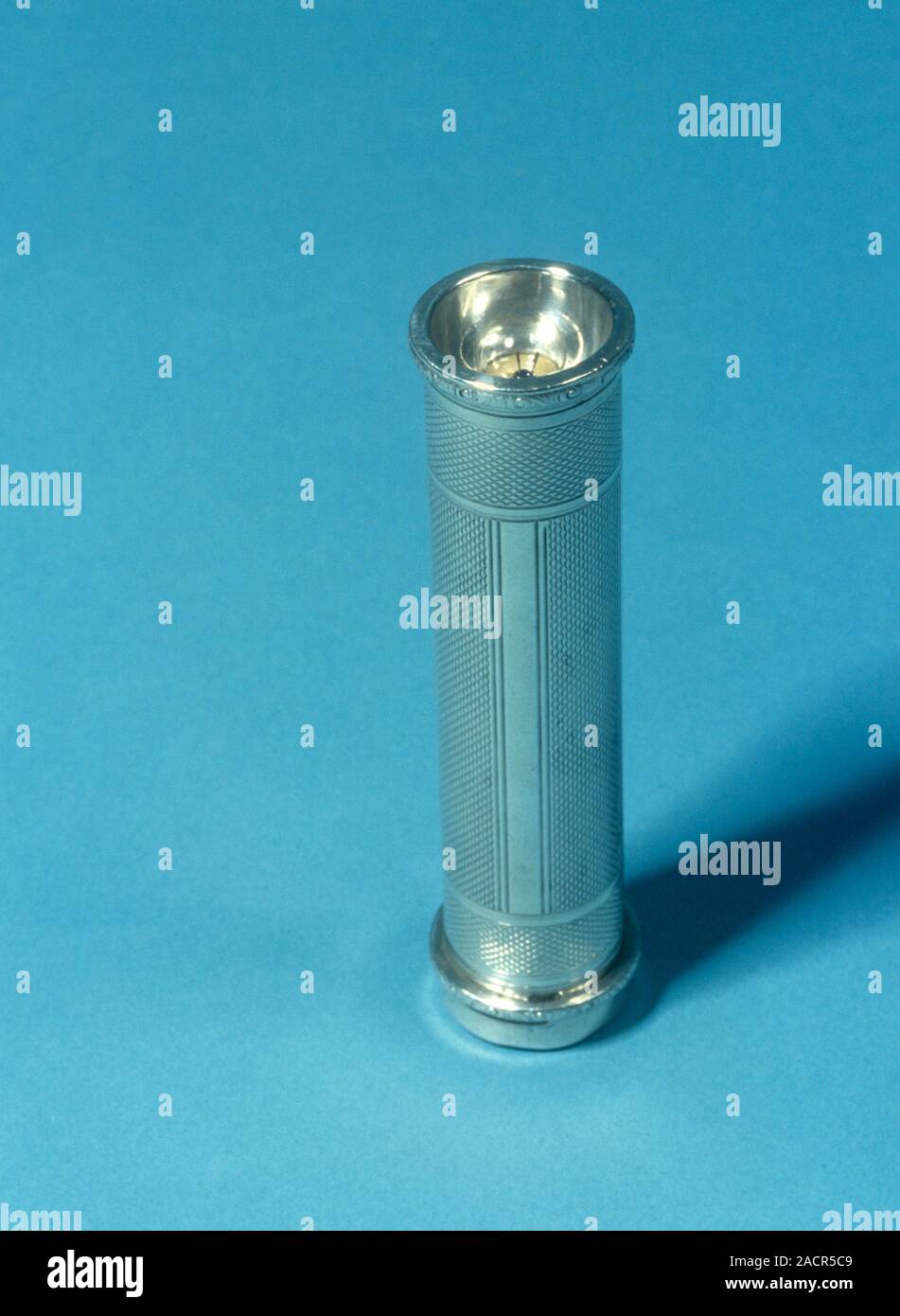 Silver clinical torch, photographed on blue background. This torch is ...