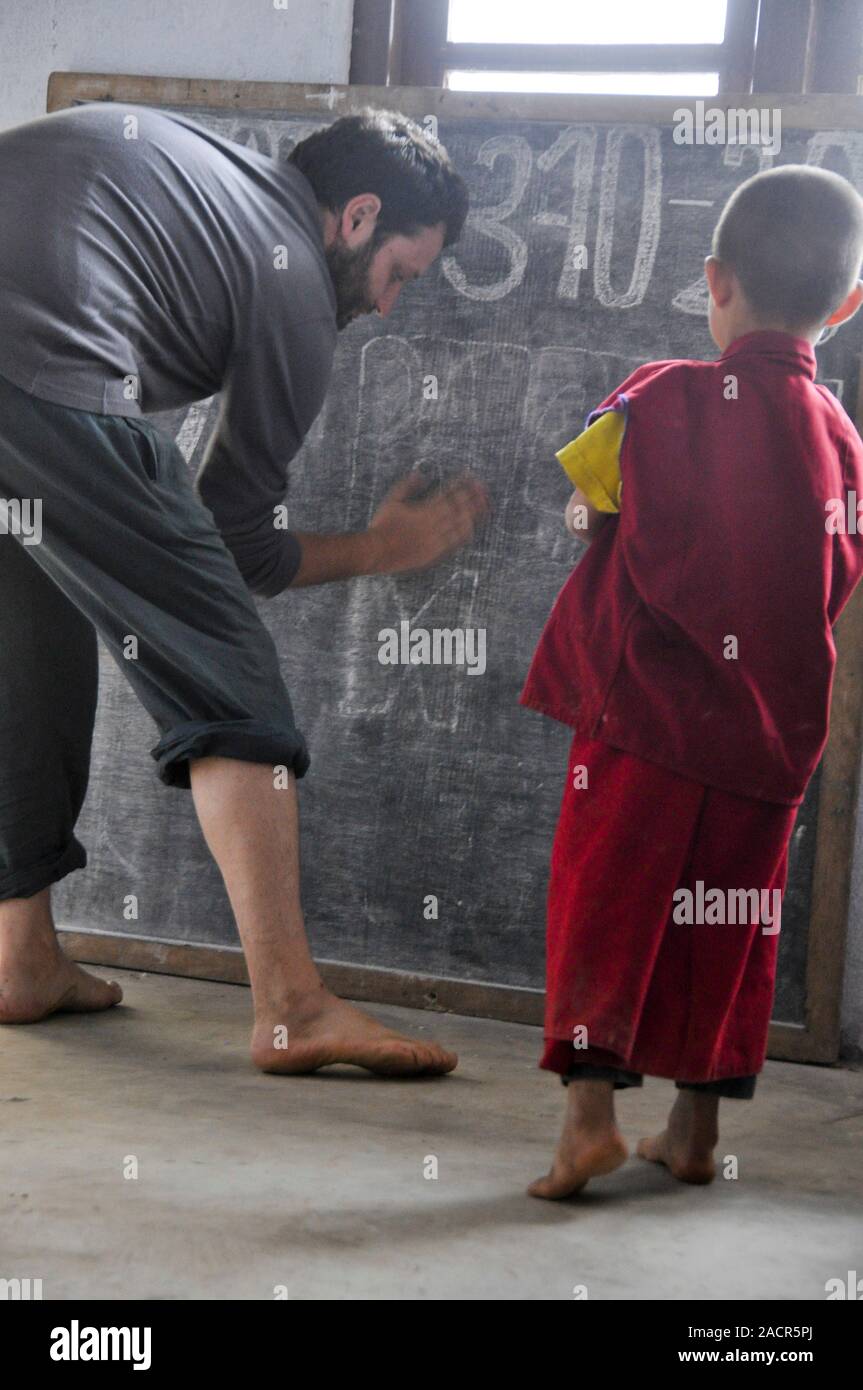 Teacher and young novice monks near the blackboard at a school in ...