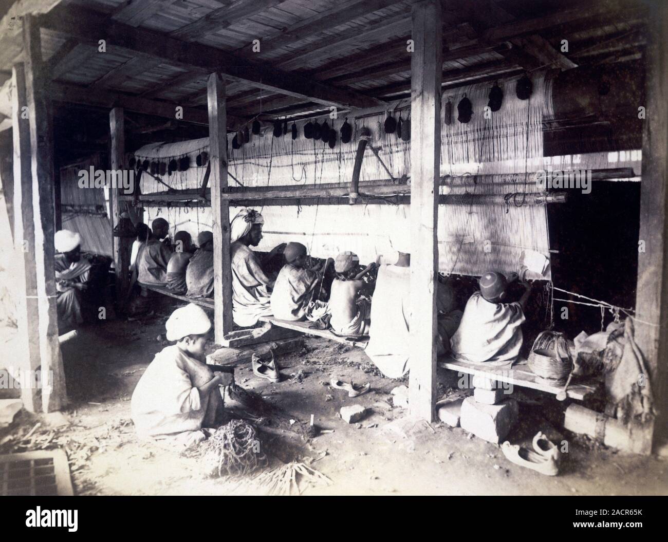Carpet weaving. Children seated at a loom weaving a carpet Stock Photo ...