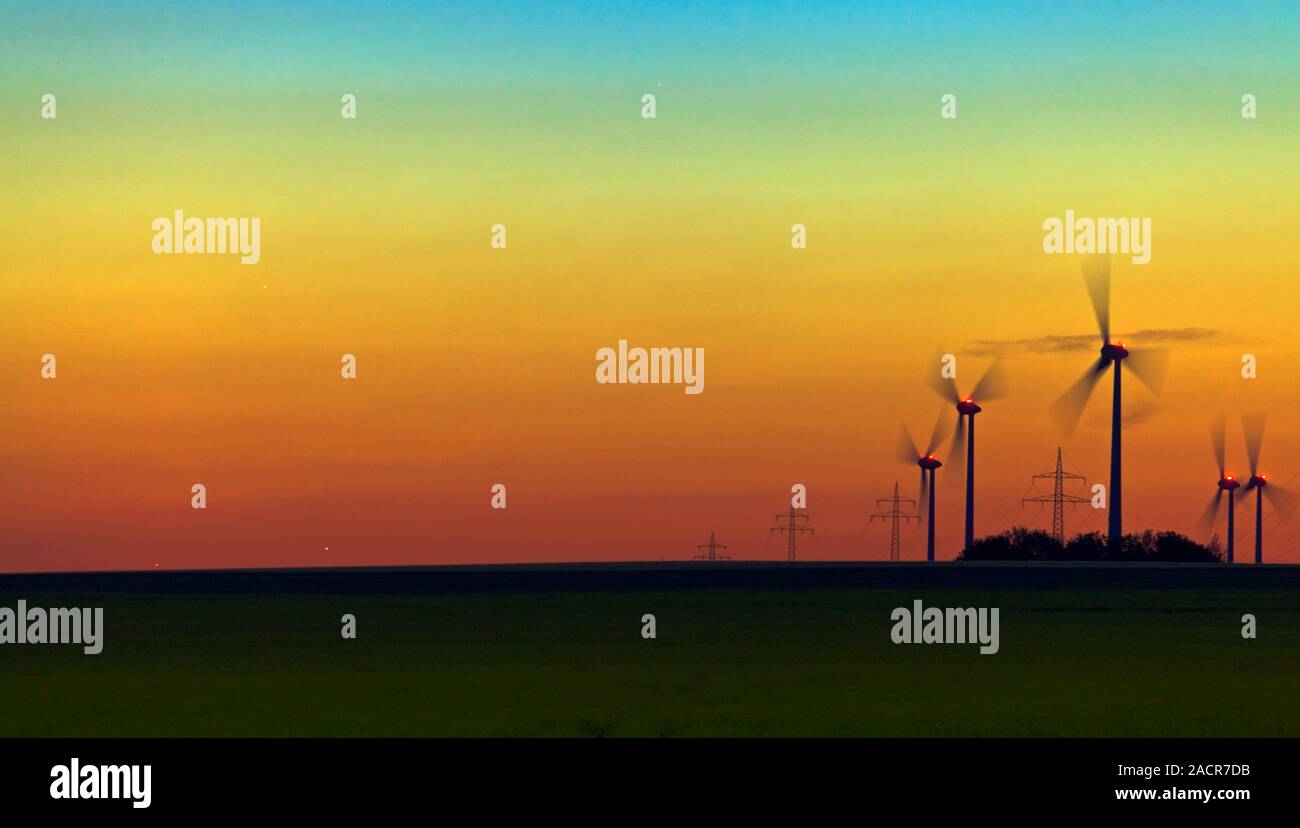 Wind turbines at sunset. Wind power is a renewable and clean source of ...