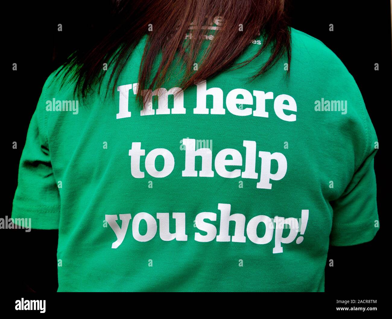 I'm here to help you shop,on the back of a retailer uniform Stock Photo ...