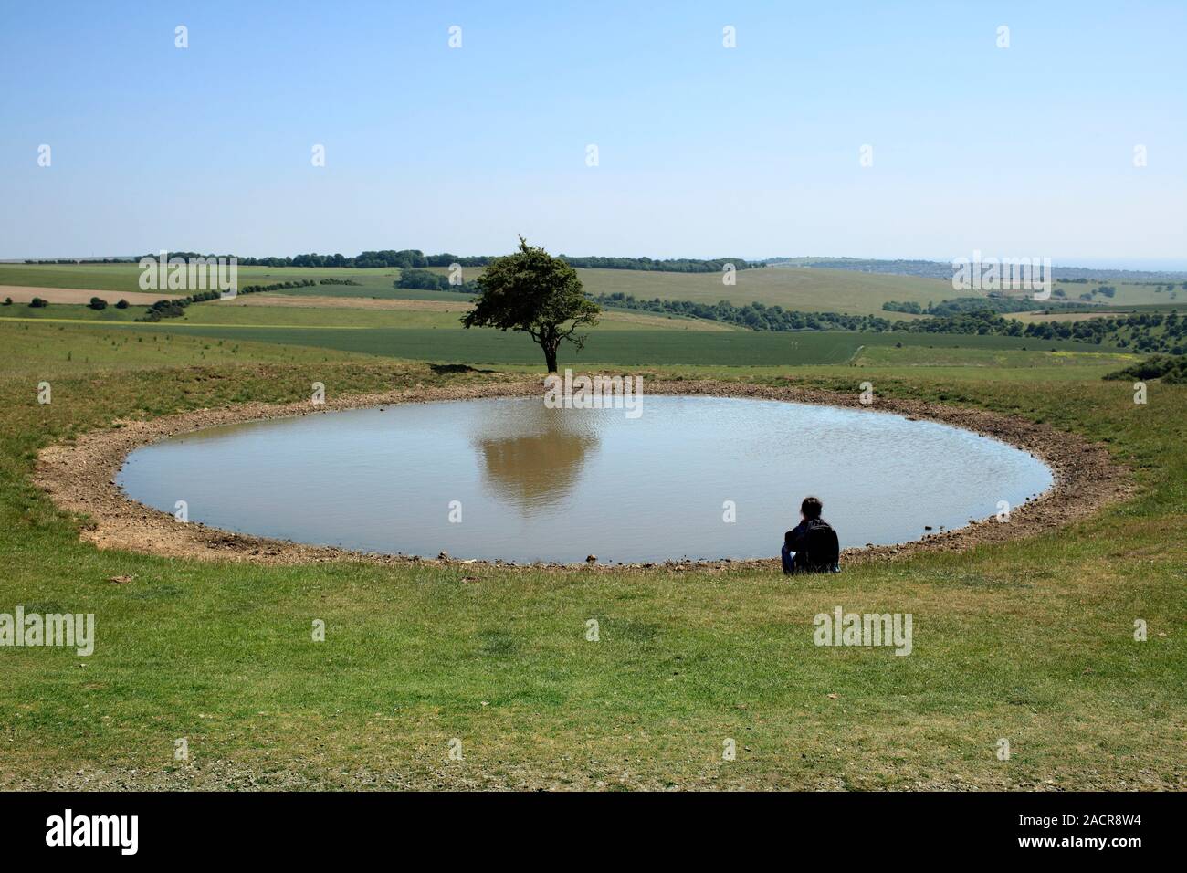 Dew pond on the South Downs, UK. Dew ponds are small round ponds ...