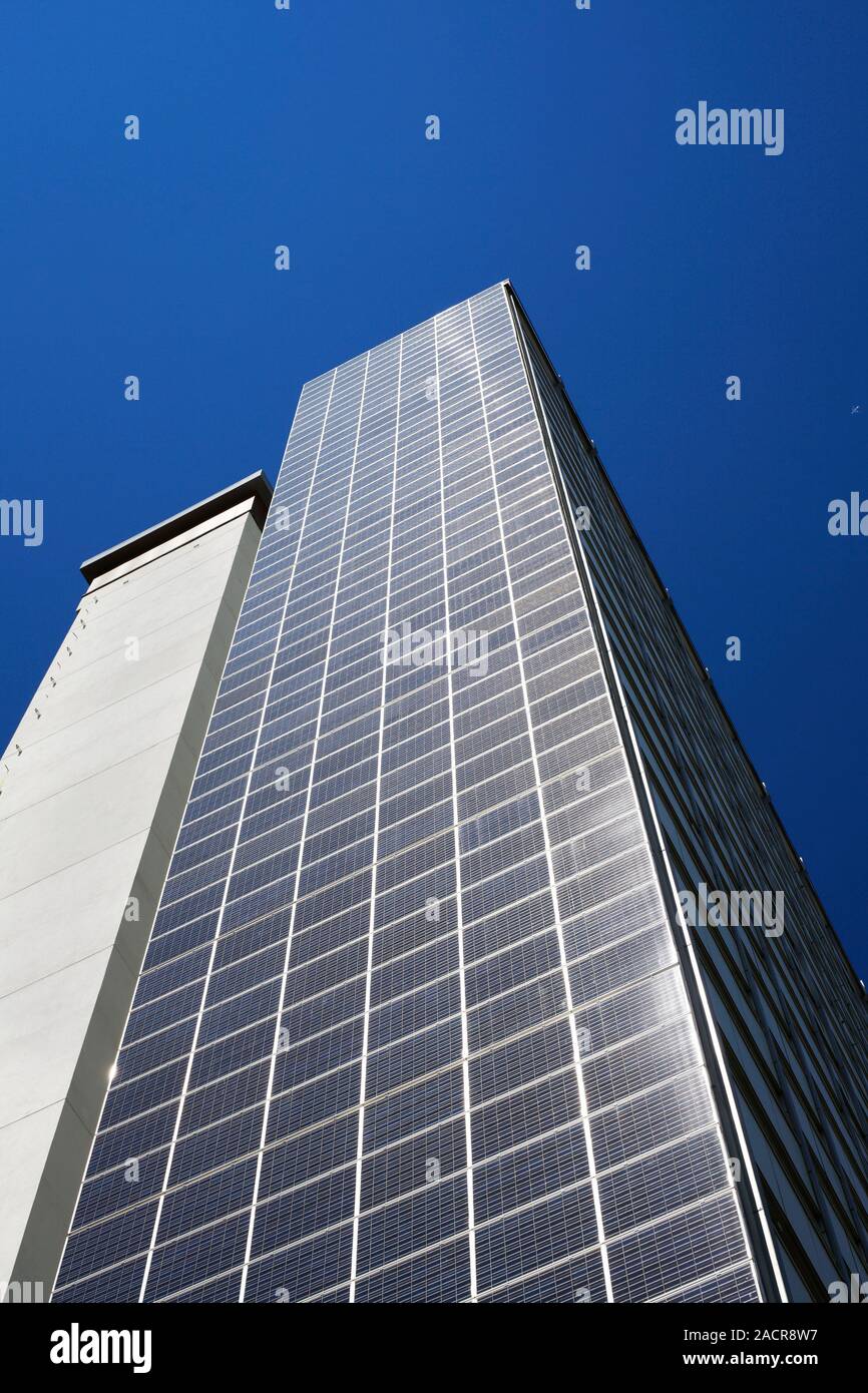 Solar-panelled housing block. Solar panels (containing photovoltaic ...