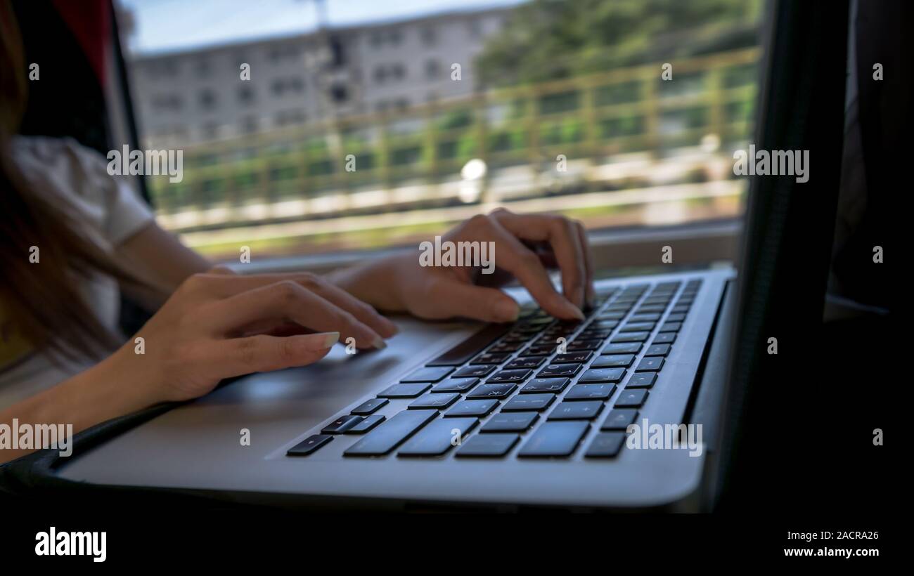 Businesswoman working with computer in the travel train. Asian young ...