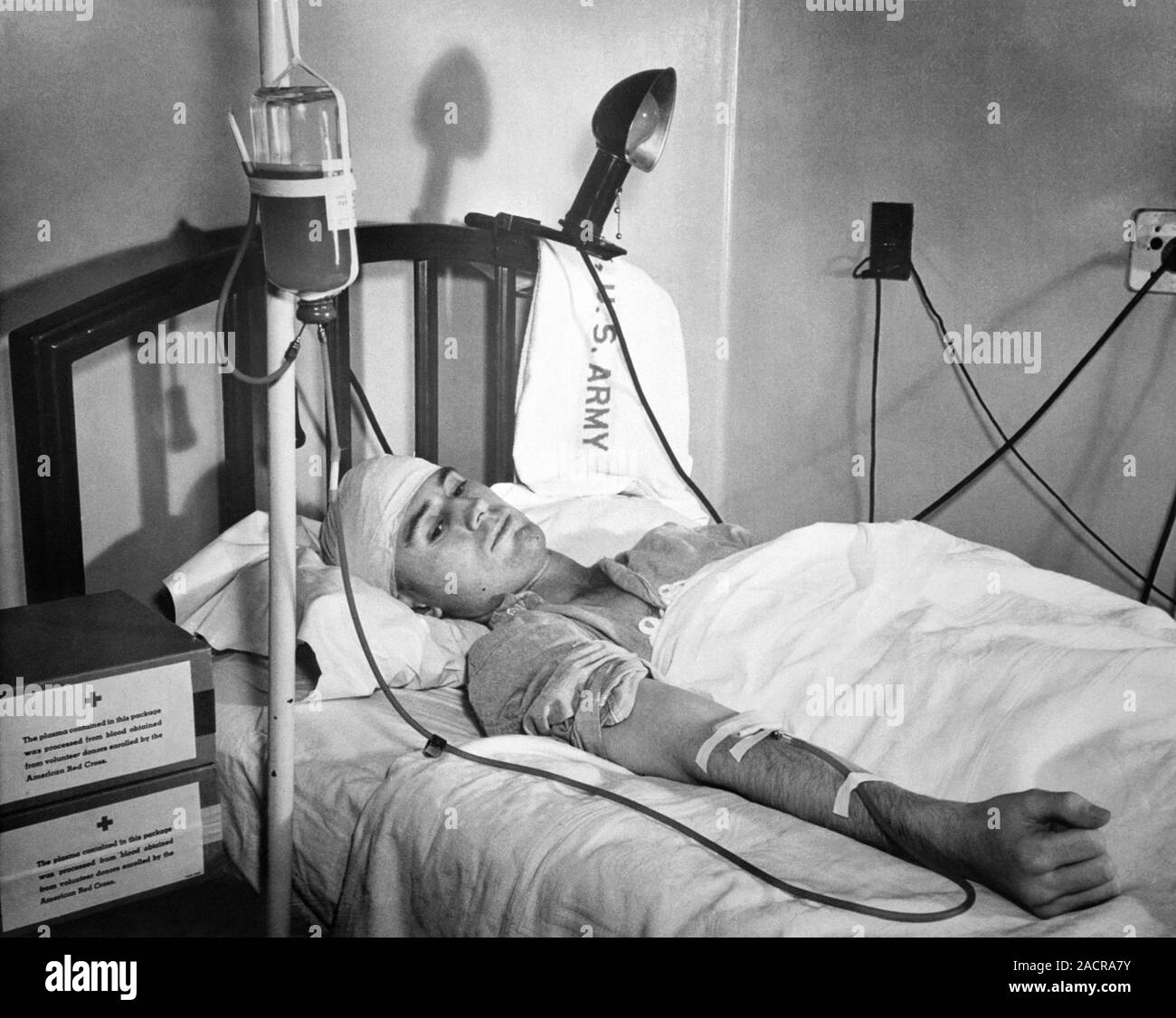 Military blood transfusion. US Army soldier receiving a transfusion of ...