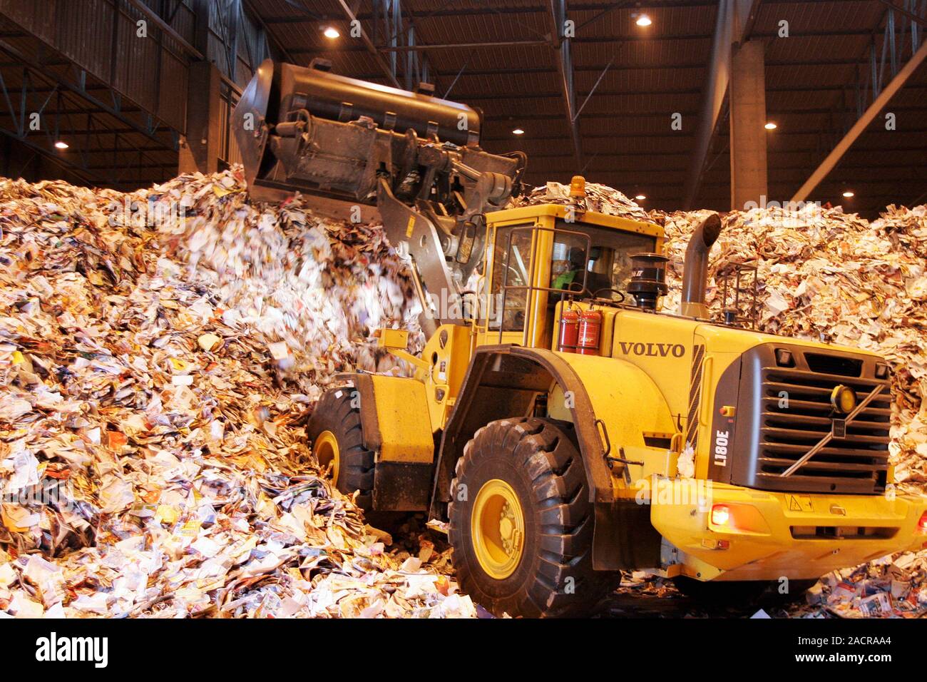 Paper mill. Mounds of waste paper to be recycled for paper production ...