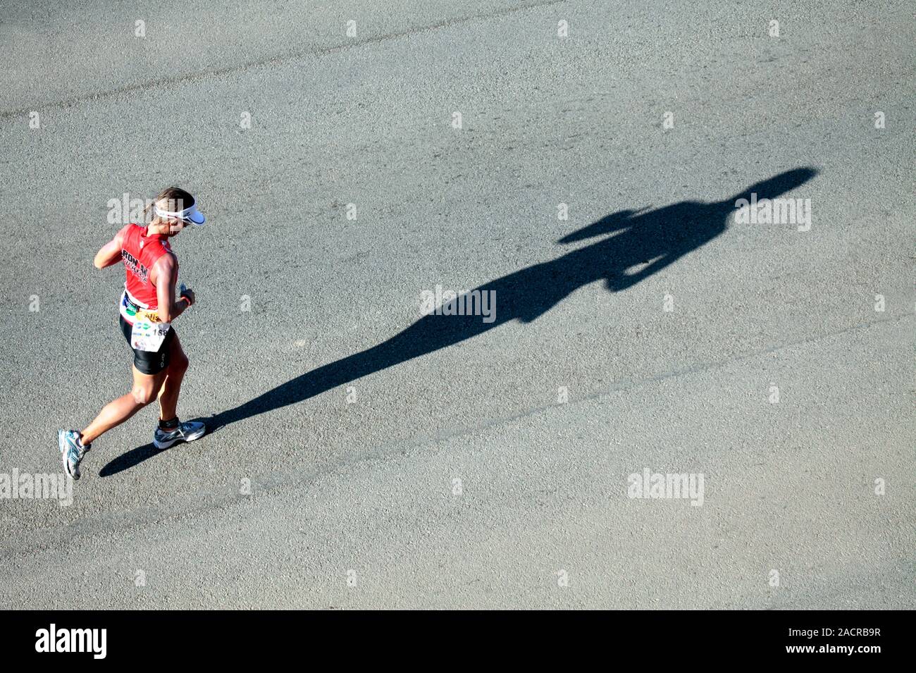 Ironman competitor. Competitor running in an ironman triathlon competition in Summerstrand, Port ...