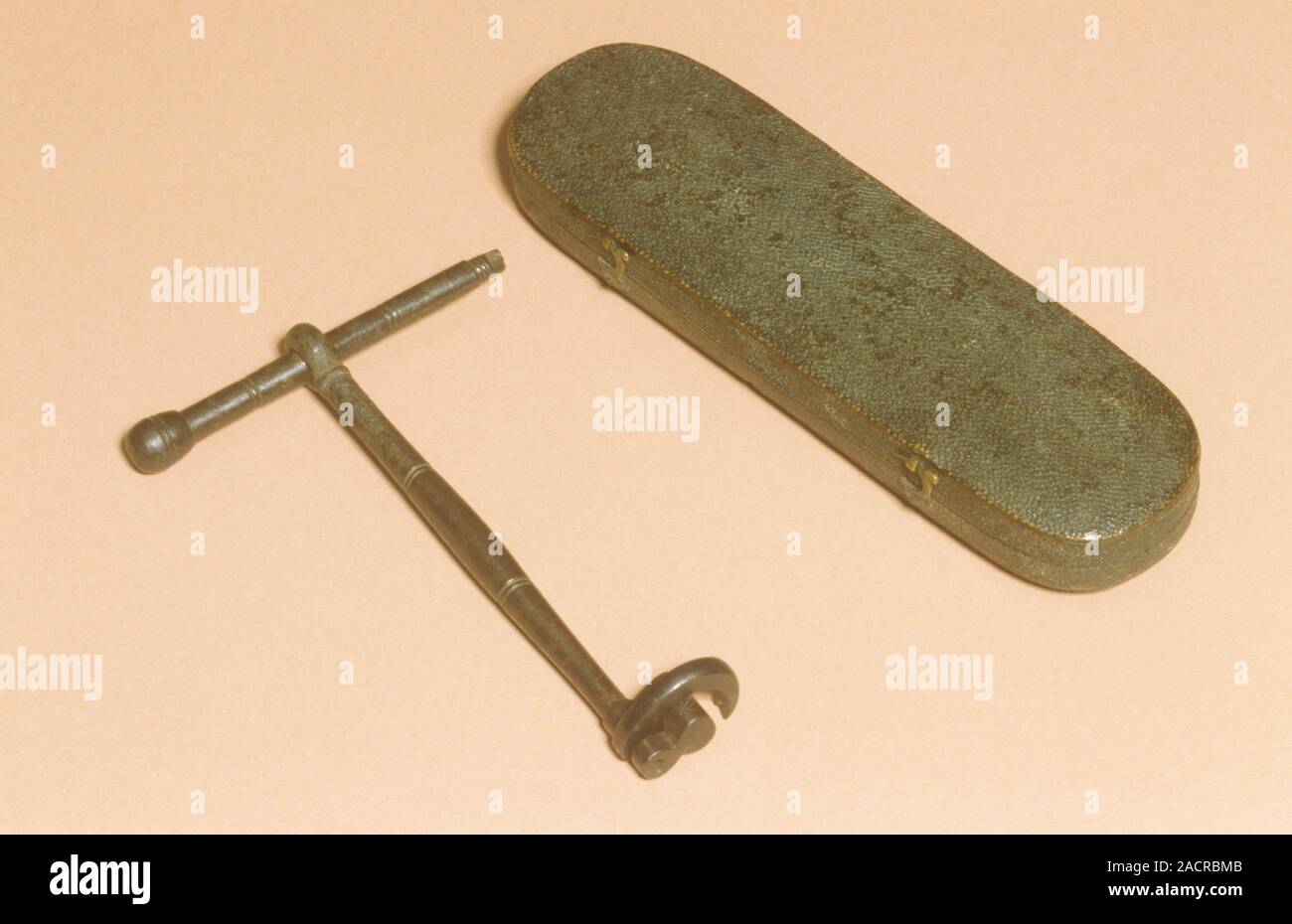 Unusual steel tooth key with three claws alongside its fish skin case ...